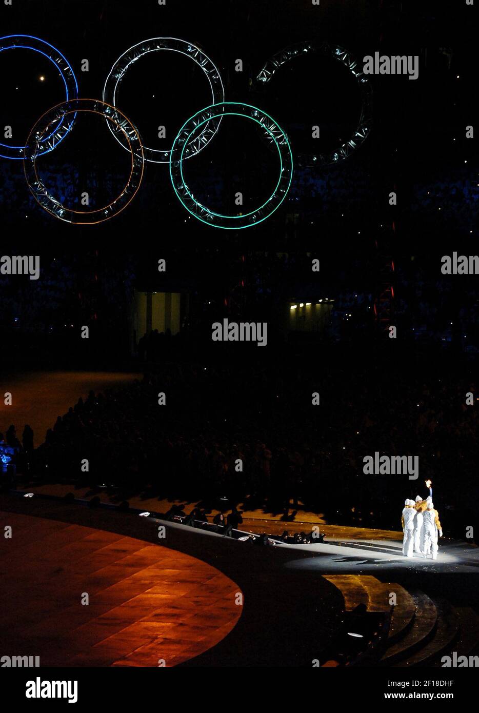 Torch bearers pass the Olympic torch at the Olympic Stadium during ...