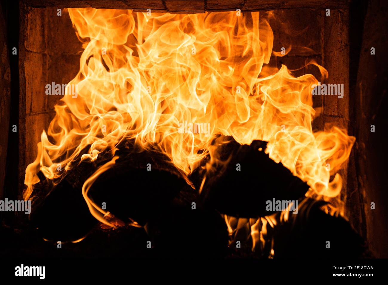 Burning wood. Cozy fire with logs. Glowing fireplace. Fire texture ...