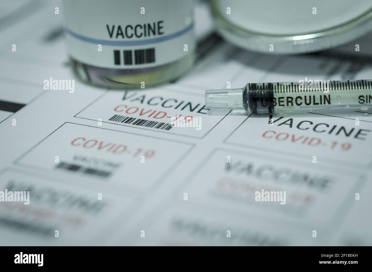 Medication labels and bottles of COVID-19 vaccine and syringe Stock ...