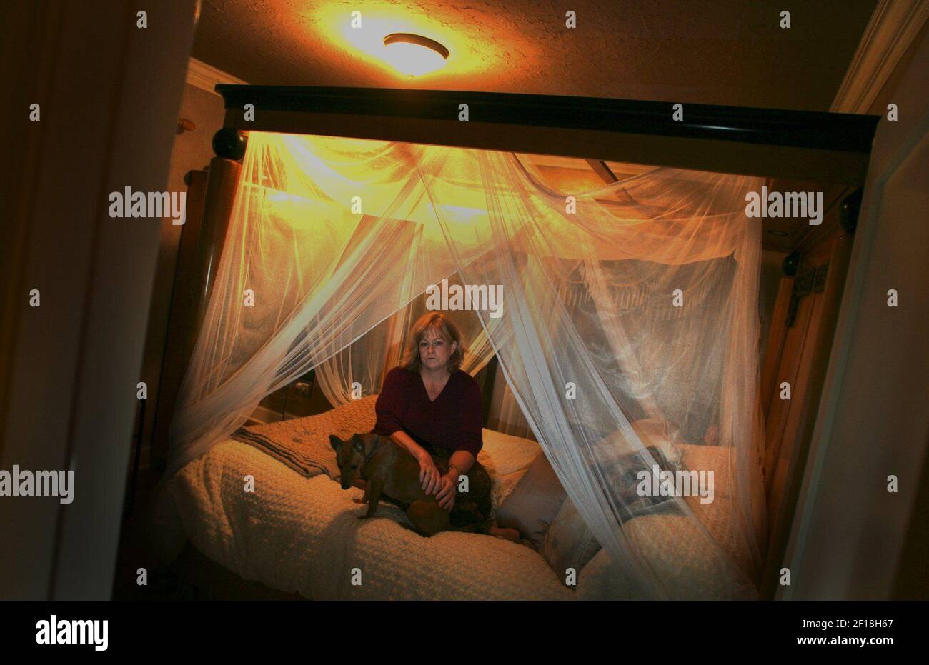 Jill Cross sits on the bed her friend Carol Ann Wikstrom laid on for ...