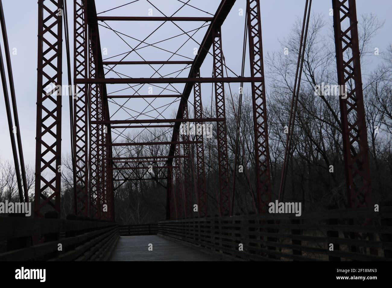 Metal walking bridge in a park Stock Photo - Alamy