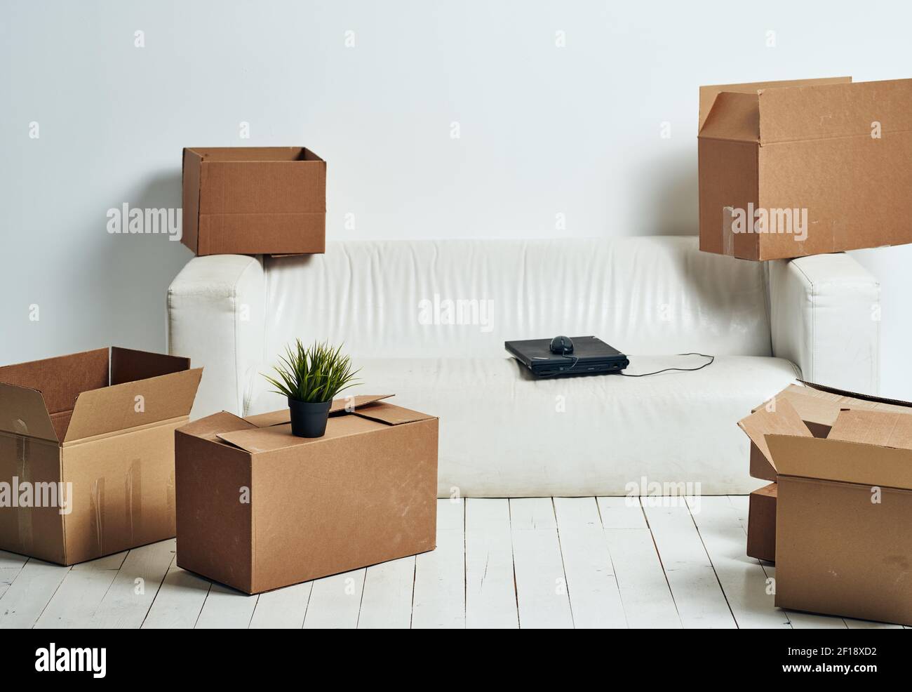 Boxes with things white sofa unpacking office moving Stock Photo - Alamy