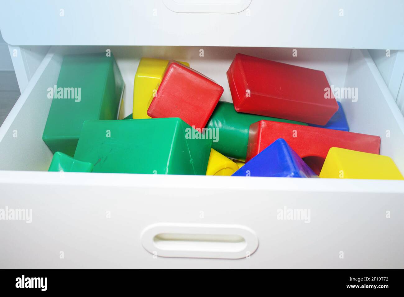 Multi-colored cubes in a drawer of a wardrobe in a children's room ...
