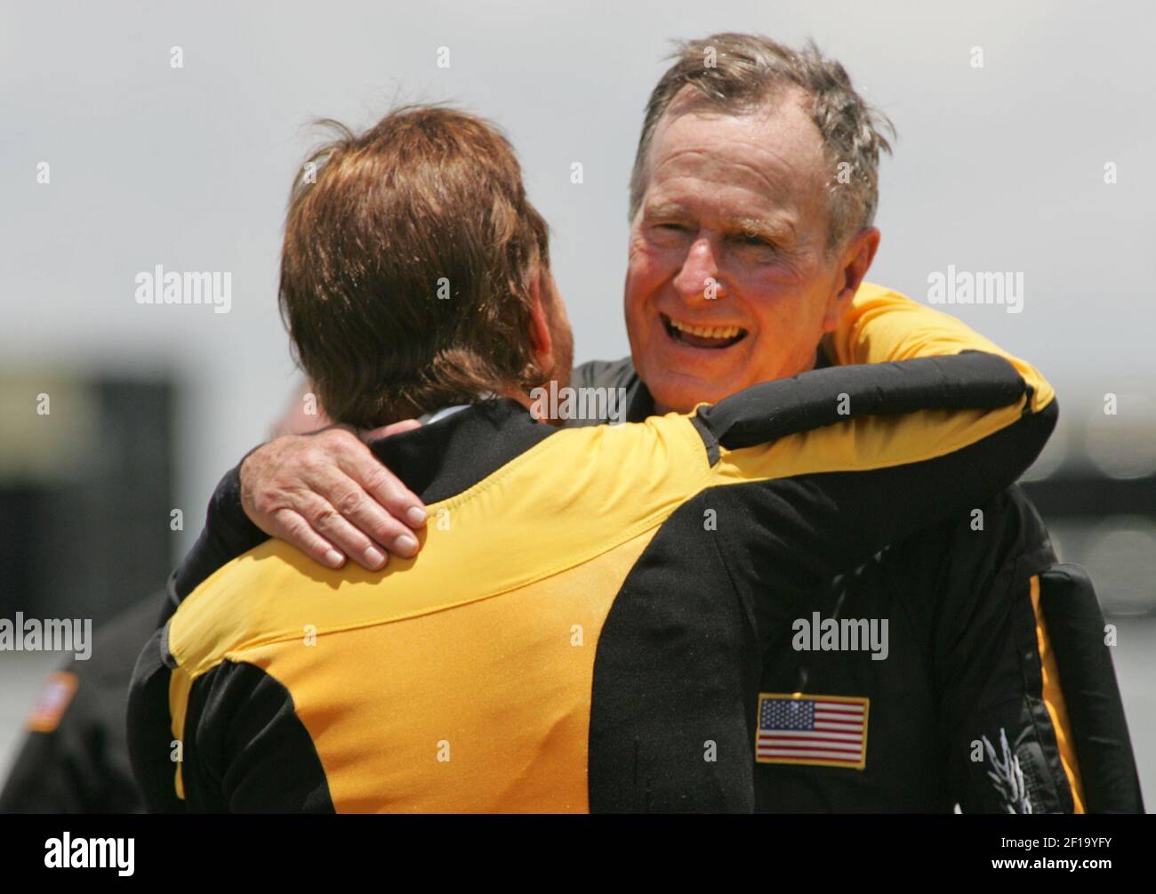 Former President George H. W. Bush hugs actor Chuck Norris after his ...