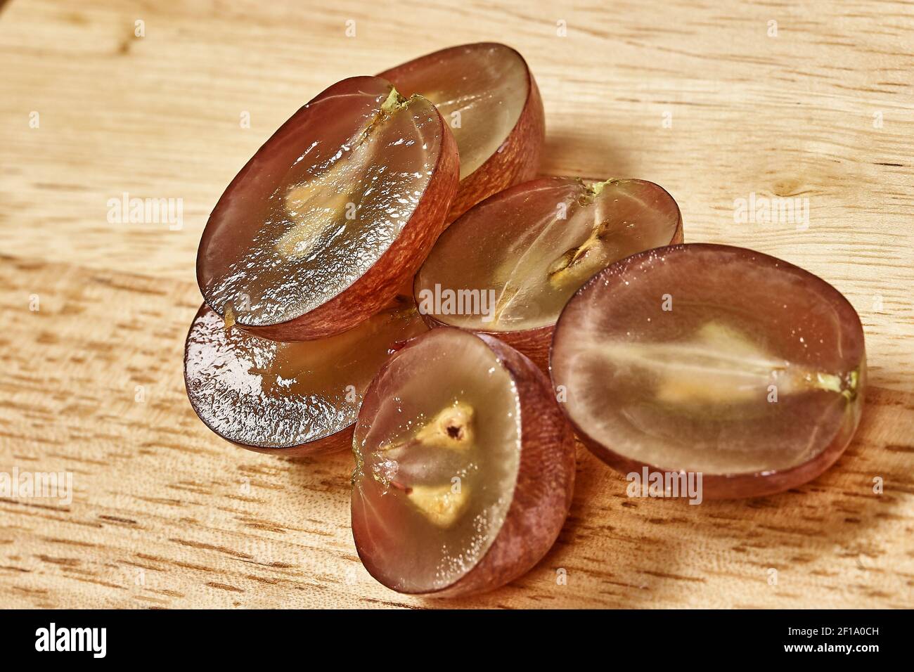 Grapes close-up cut in half on board Stock Photo - Alamy