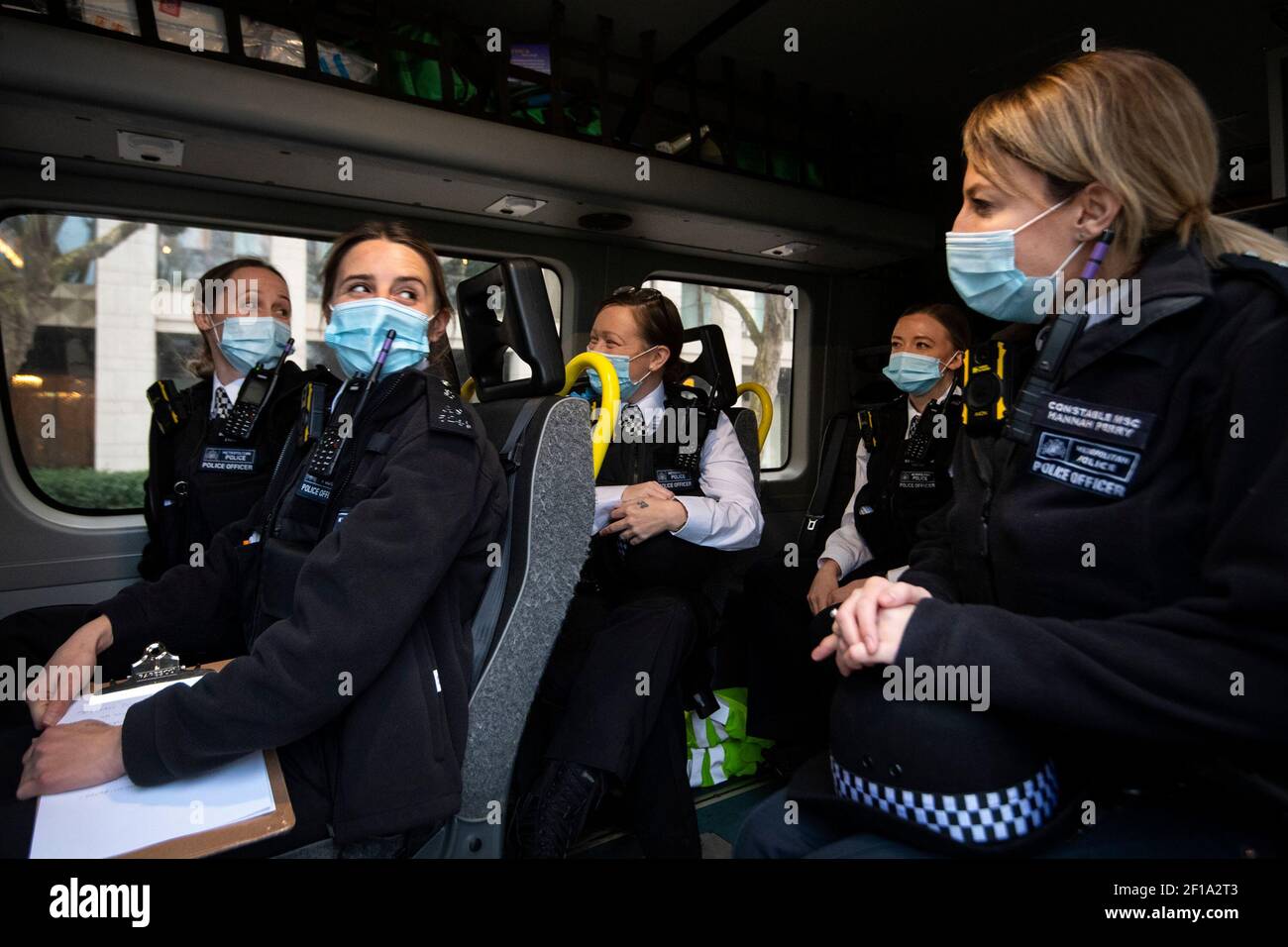 Female police officers and special constables sit in their vehicle ...
