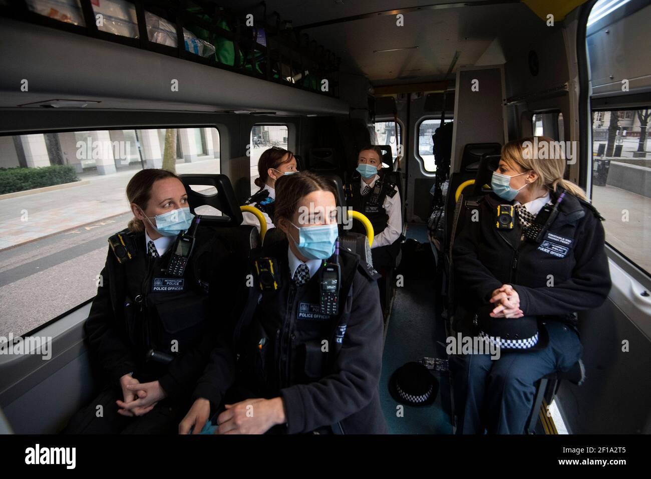 Female police officers and special constables sit in their vehicle ...