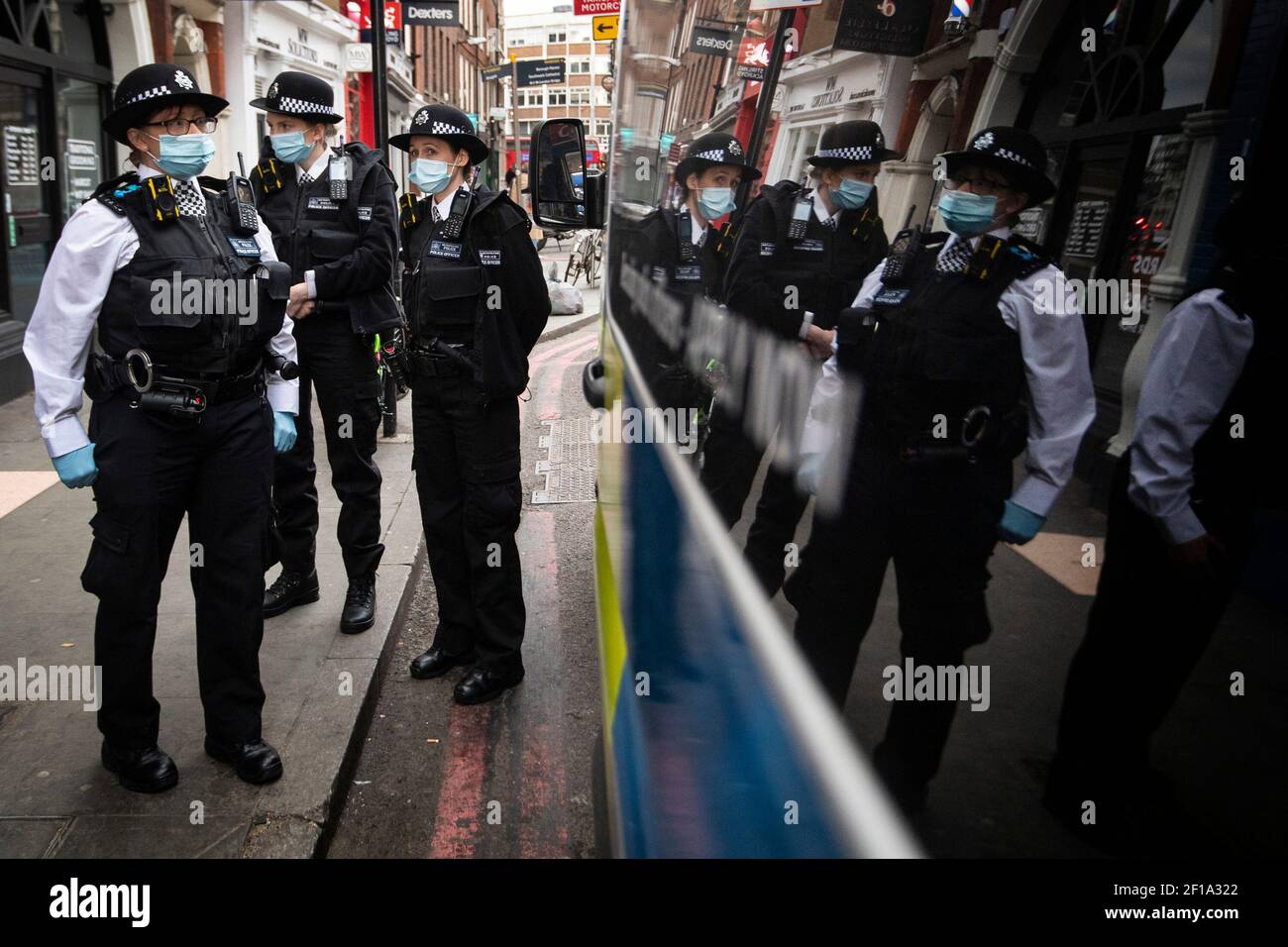 Female police officers and special constables return to their vehicle ...