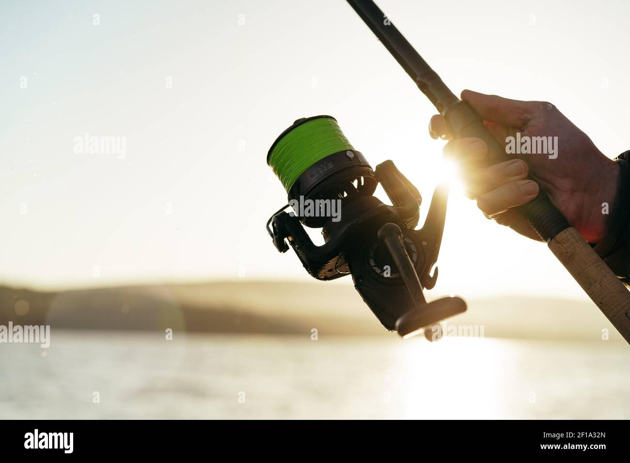 Fisherman hands holding fishing rod close up Stock Photo - Alamy
