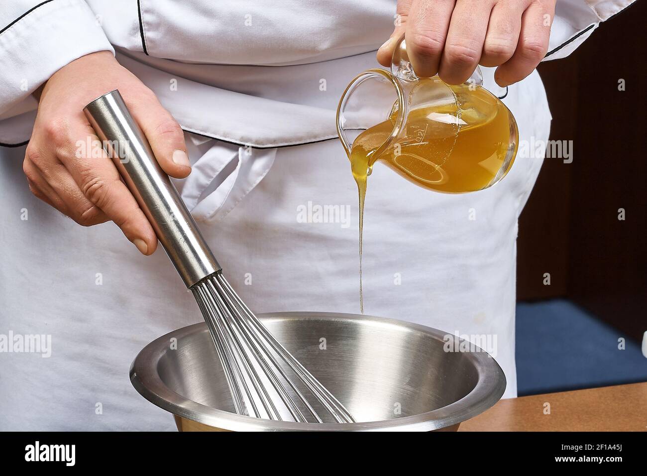Close up of pouring honey from pitcher in jar Stock Photo - Alamy