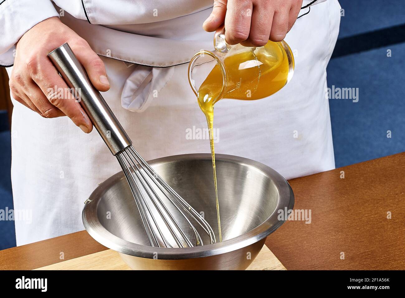 Close up of pouring honey from pitcher in jar Stock Photo - Alamy