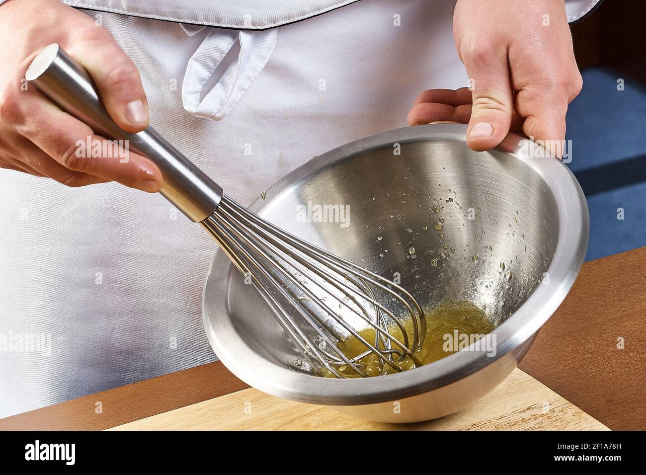 Whisking vigorously to disperse oil Making Mayonnaise oil Stock Photo ...
