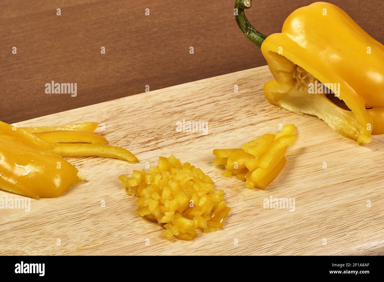 Closeup on hands cutting yellow pepper on professional kitchen Stock ...