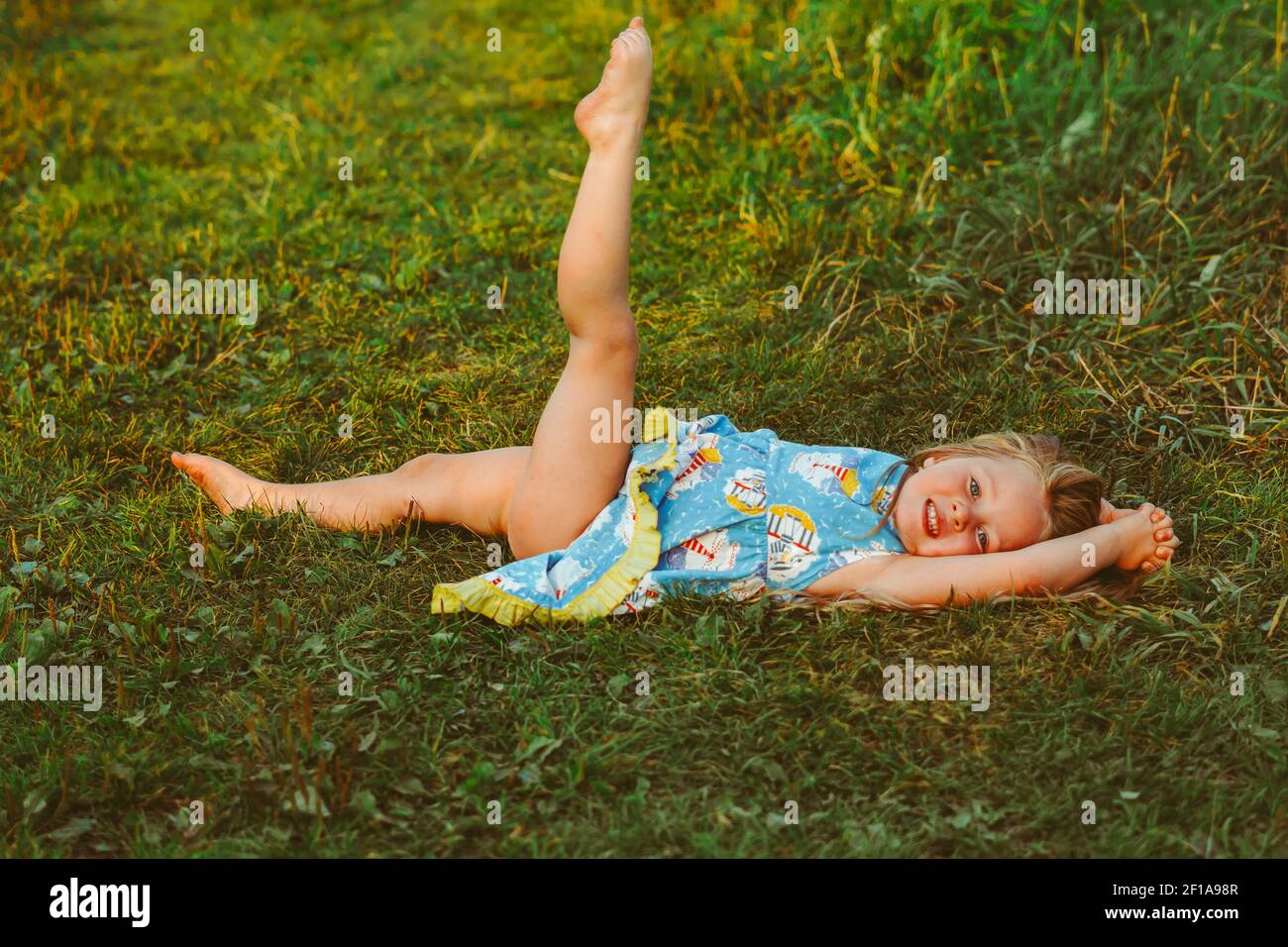 little girl resting on soft pillow in fresh spring grass Stock Photo - Alamy