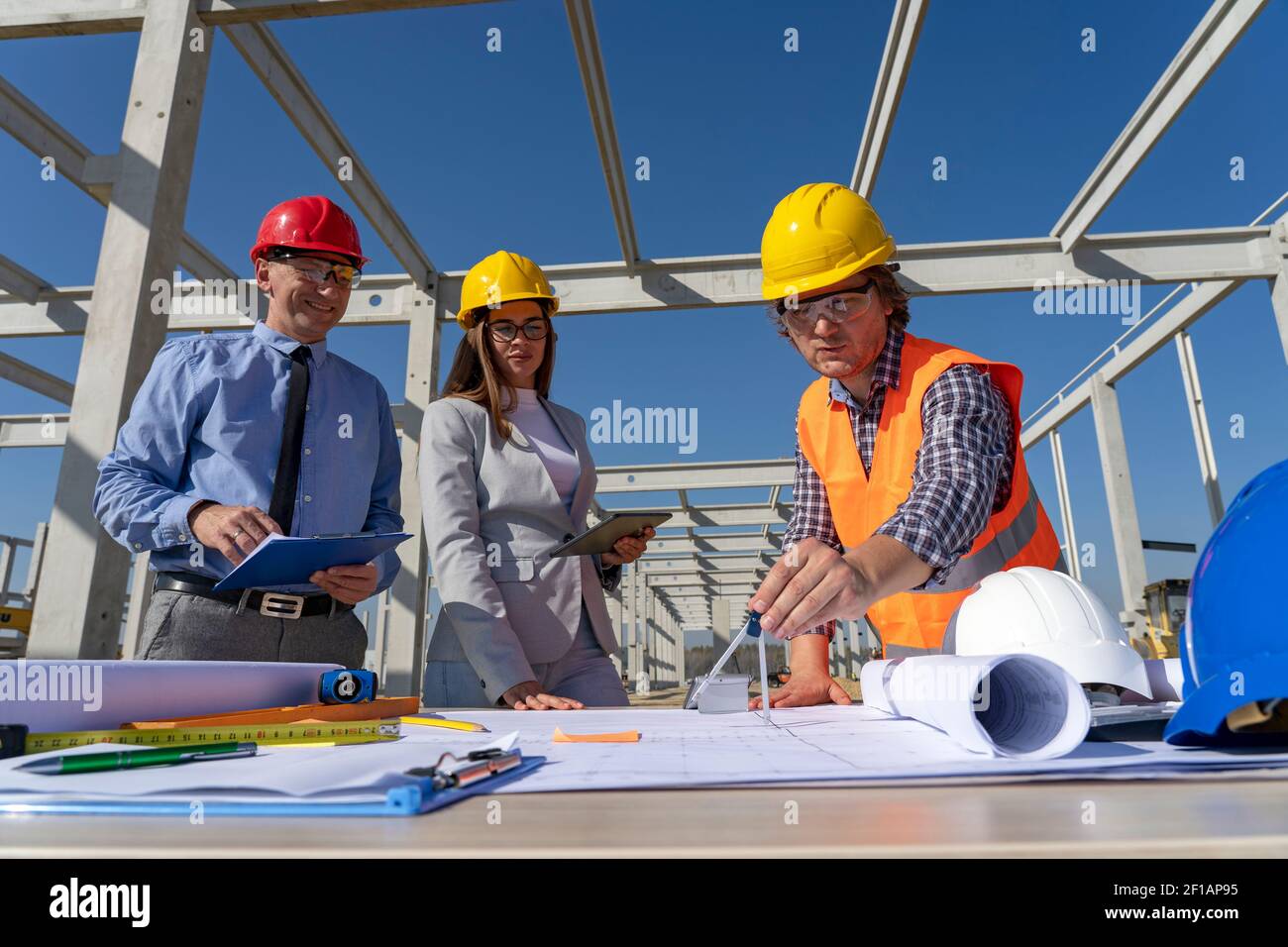 Engineer, Architect and Smiling Businessman Checking the Construction ...
