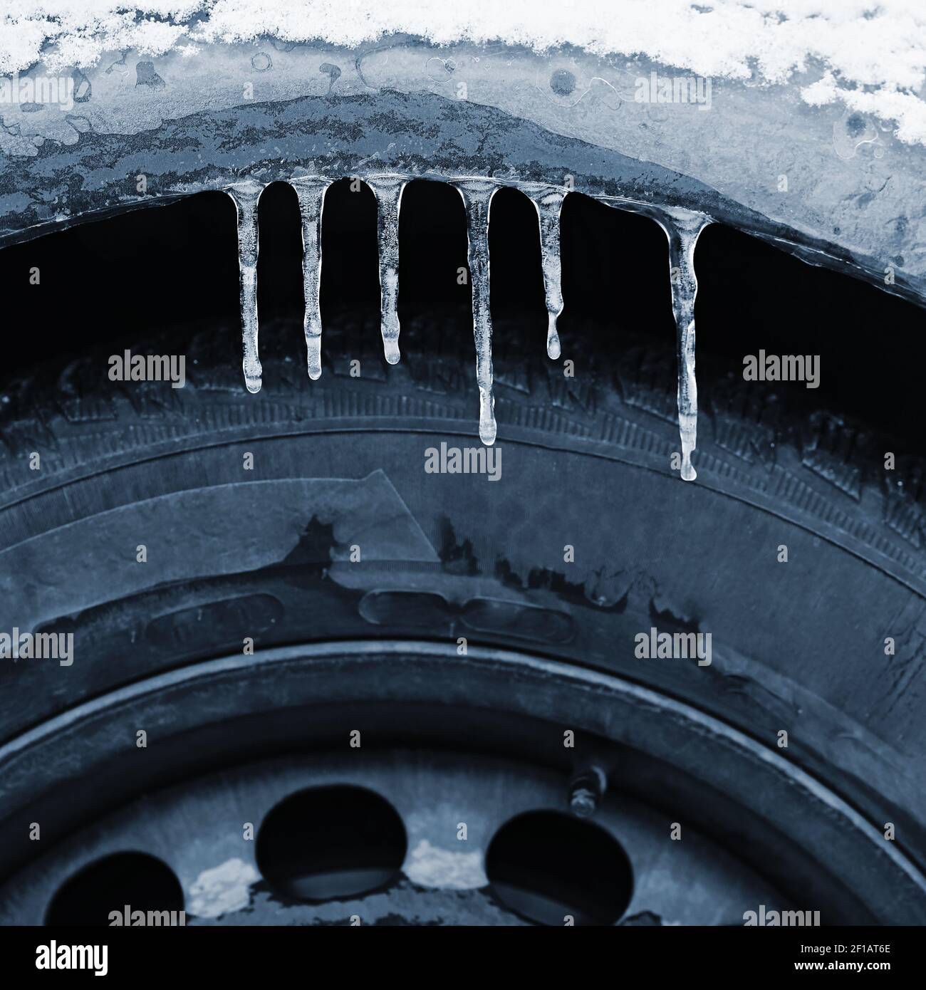 Frozen car with a tire. Icicles on the car. Concept for winter and ...