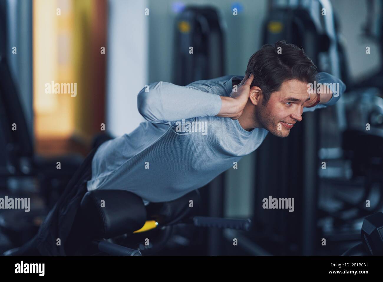 Adult man working out in a gym Stock Photo - Alamy