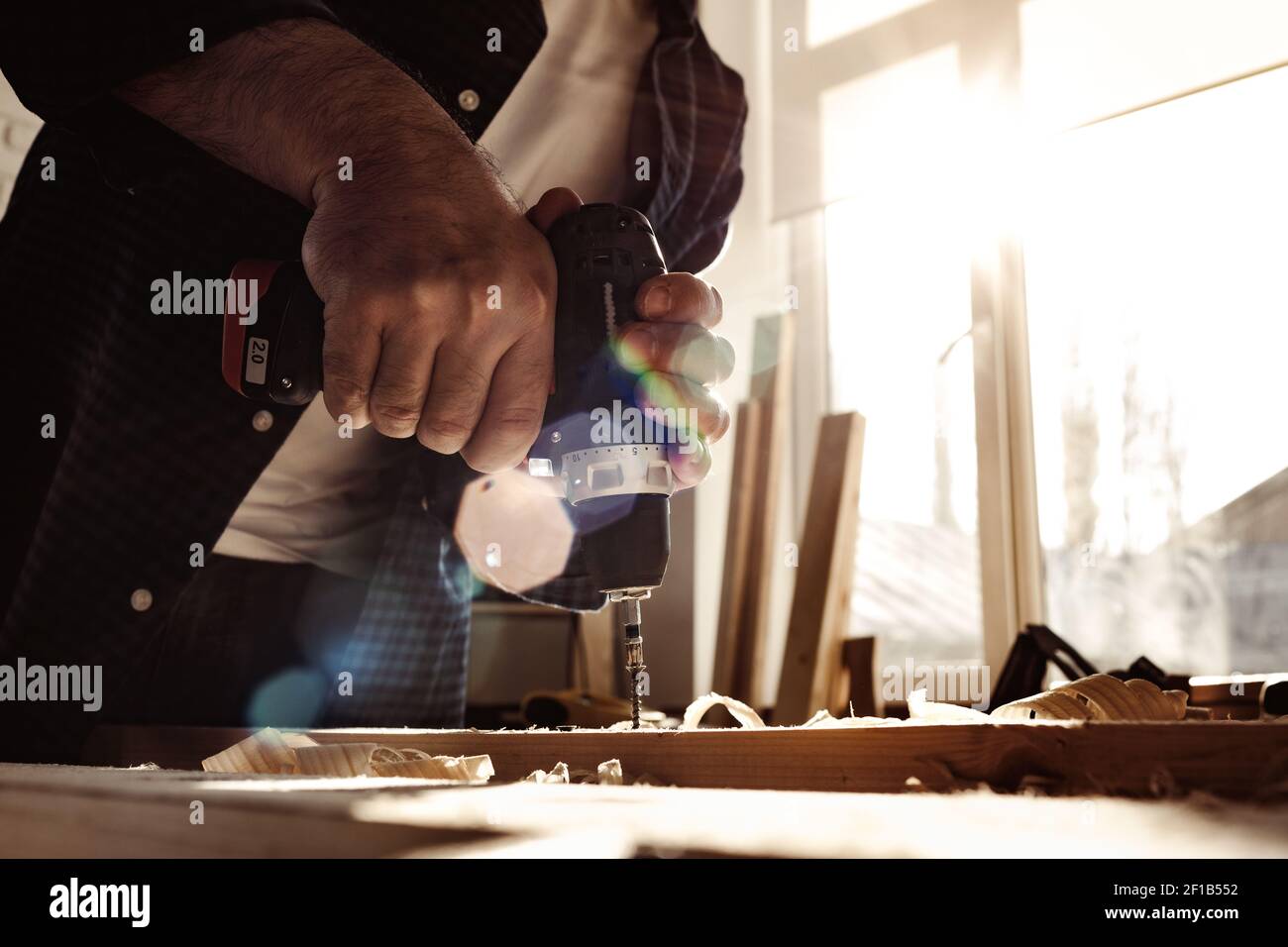 Close up of a carpenter drilling a hole in timber Stock Photo - Alamy