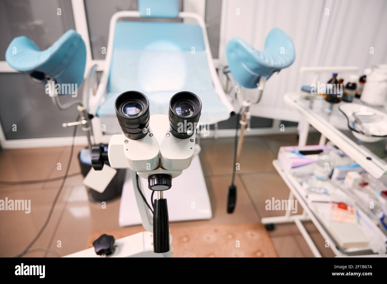 Focus on optical instrument for colposcopy in gynecological cabinet ...