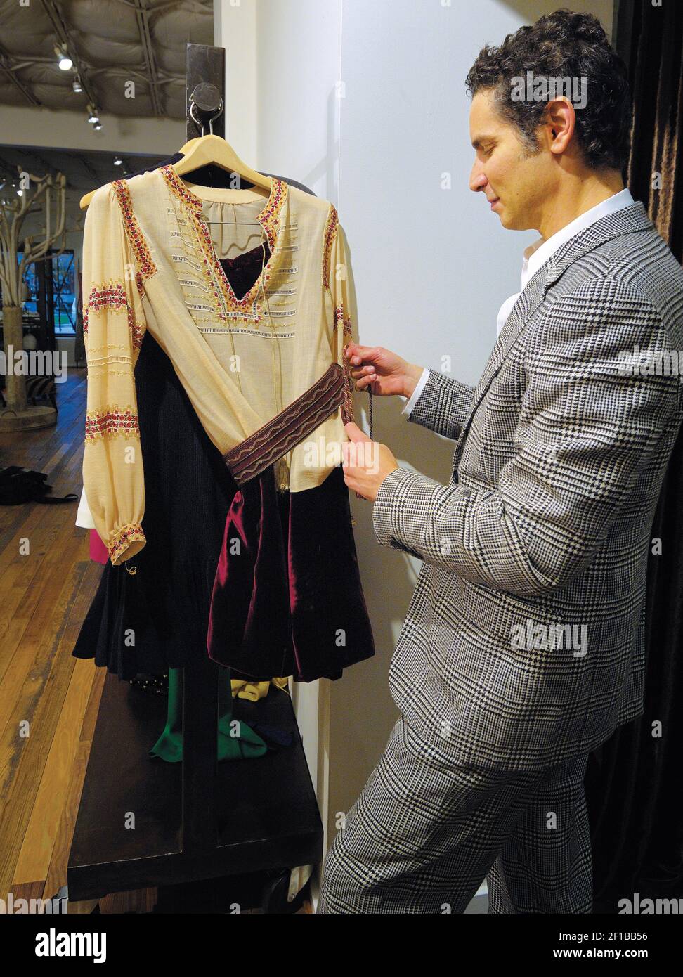 Vintage couture expert Cameron Silver adjusts a belt on a vintage Yves ...