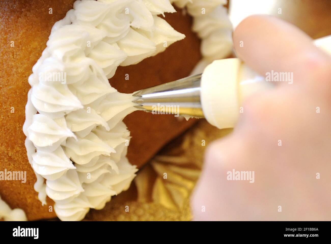 Star tipped icing tips are used to decorate a "fluffy" bunny cake. A ...