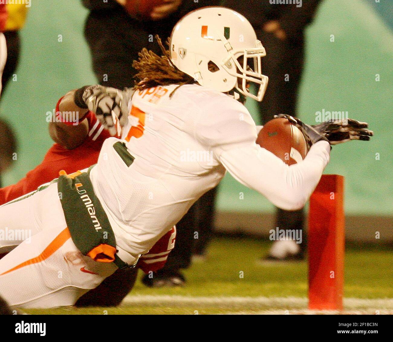 Miami running back Graig Cooper lunges into the end zone for a ...