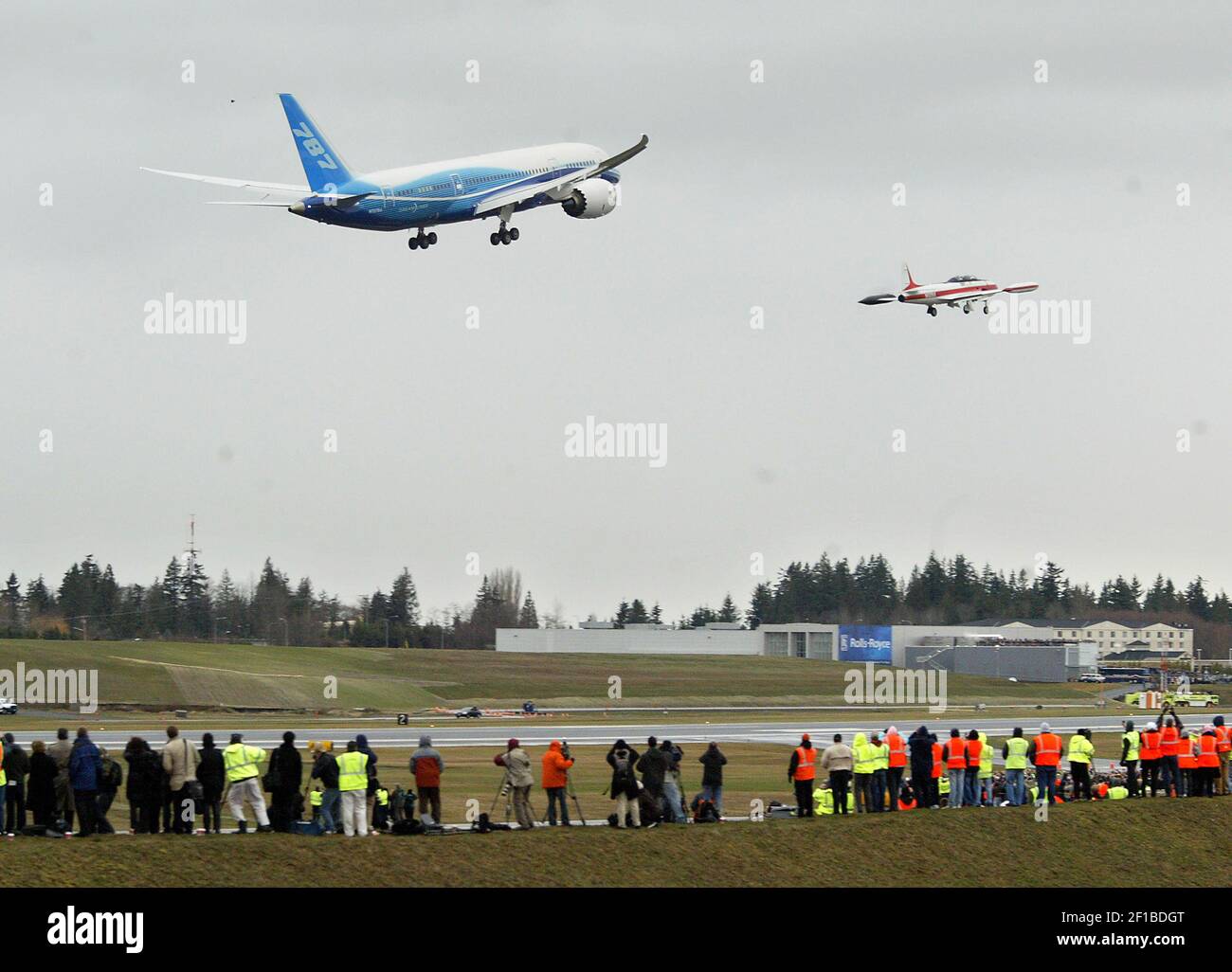 A Boeing 787 Dreamliner, left, takes off from Paine Field on its very ...