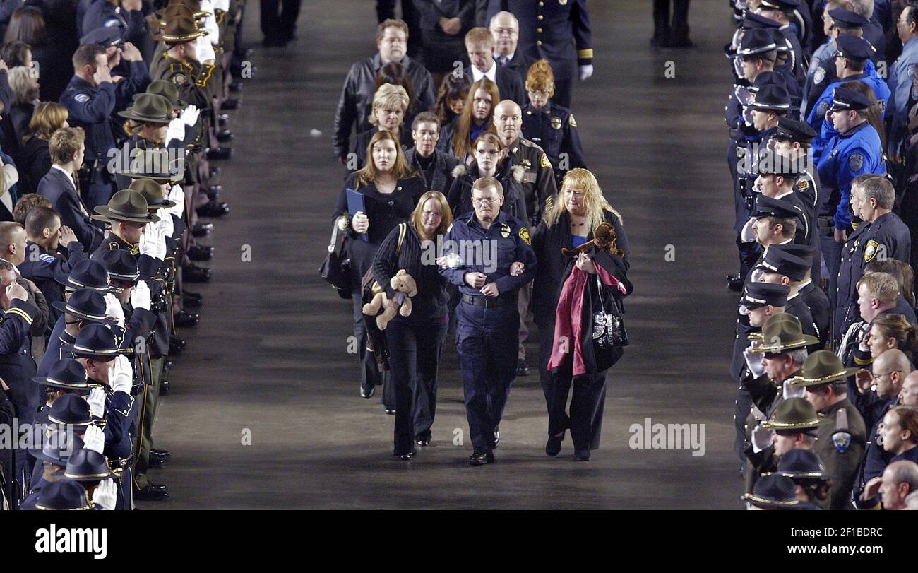 Grieving family members of the Lakewood police officers leave the floor ...
