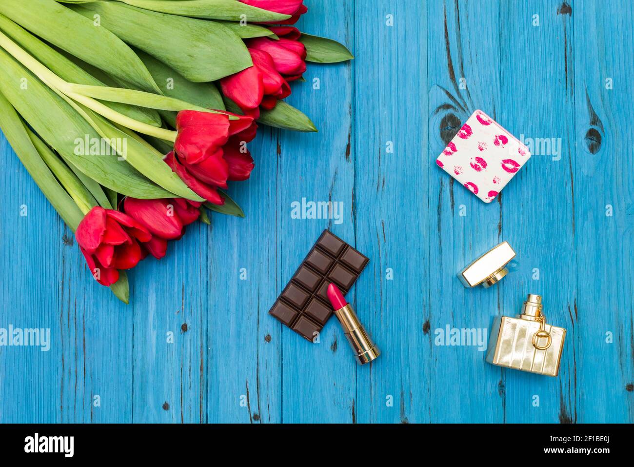 Red tulips on a blue wooden board Stock Photo - Alamy