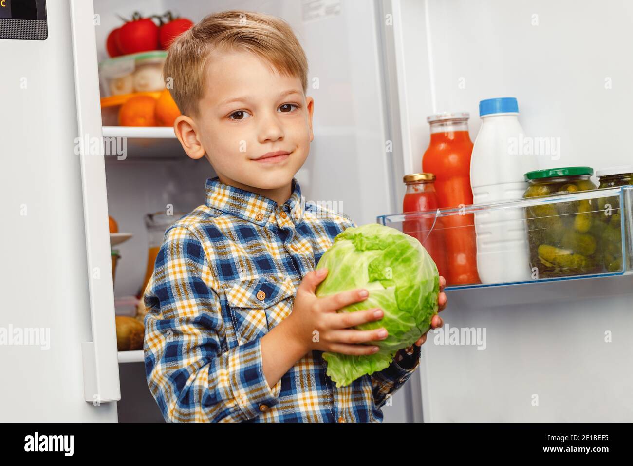 Little boy standing near the open fridge Stock Photo - Alamy