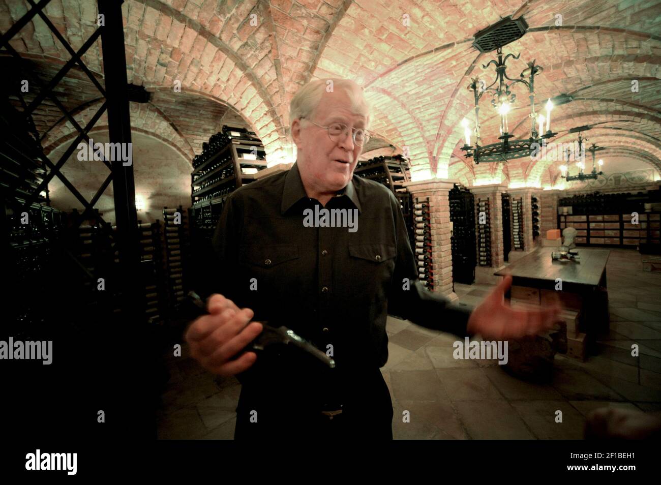 William Koch holds a bottle of wine in the wine cellar of his home on ...