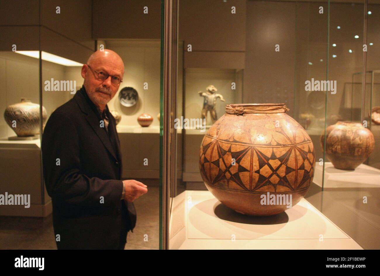 Curator Gaylord Torrence stands next to a Southwest jar, dating from ...