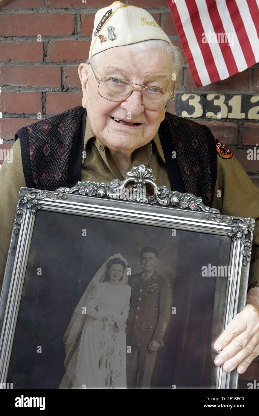 John Joniec, a survivor of the attack on Pearl Harbor, holds a picture ...
