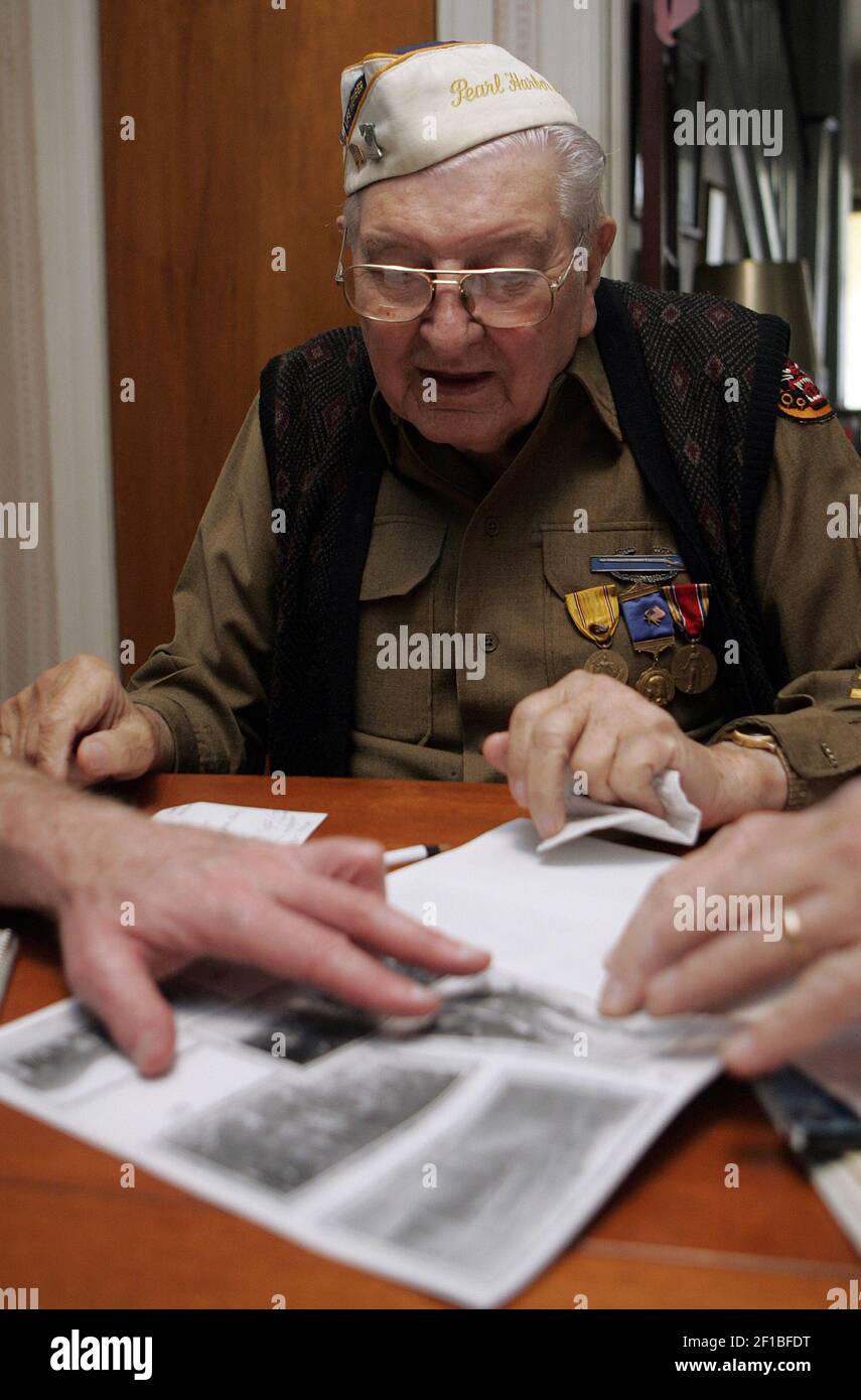 John Joniec, a survivor of the attack on Pearl Harbor, looks through ...