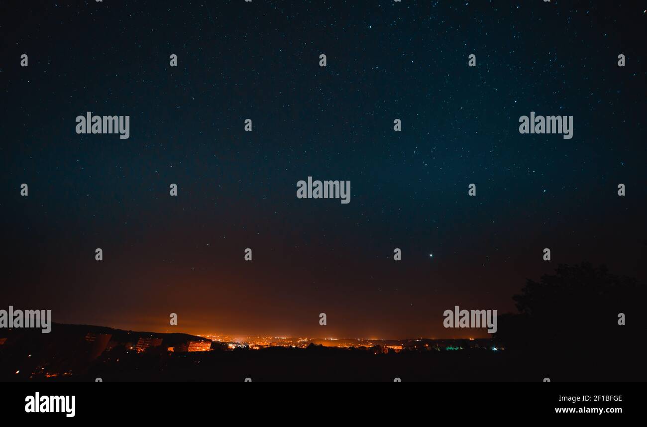 The starry sky over the night city Stock Photo - Alamy