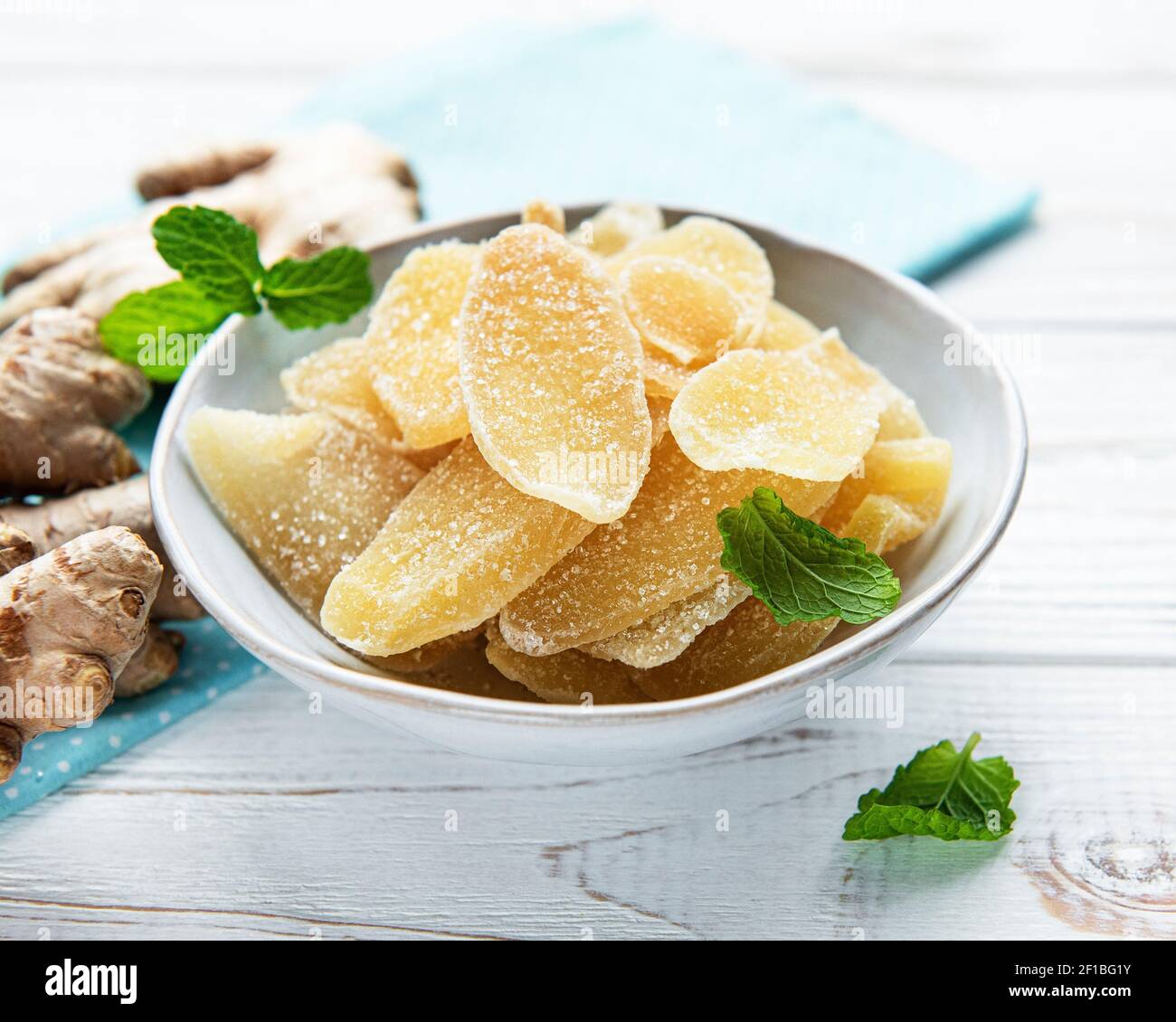 Sweet and spicy candied ginger on a old white wooden table Stock Photo ...