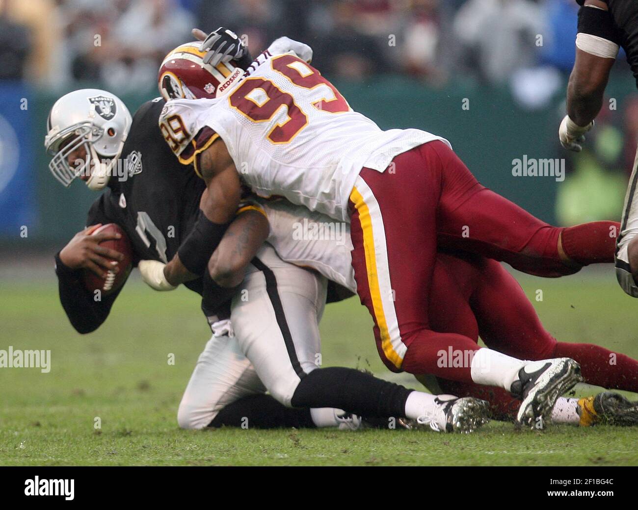 Oakland Raiders quarterback JaMarcus Russell, left, is sacked by ...
