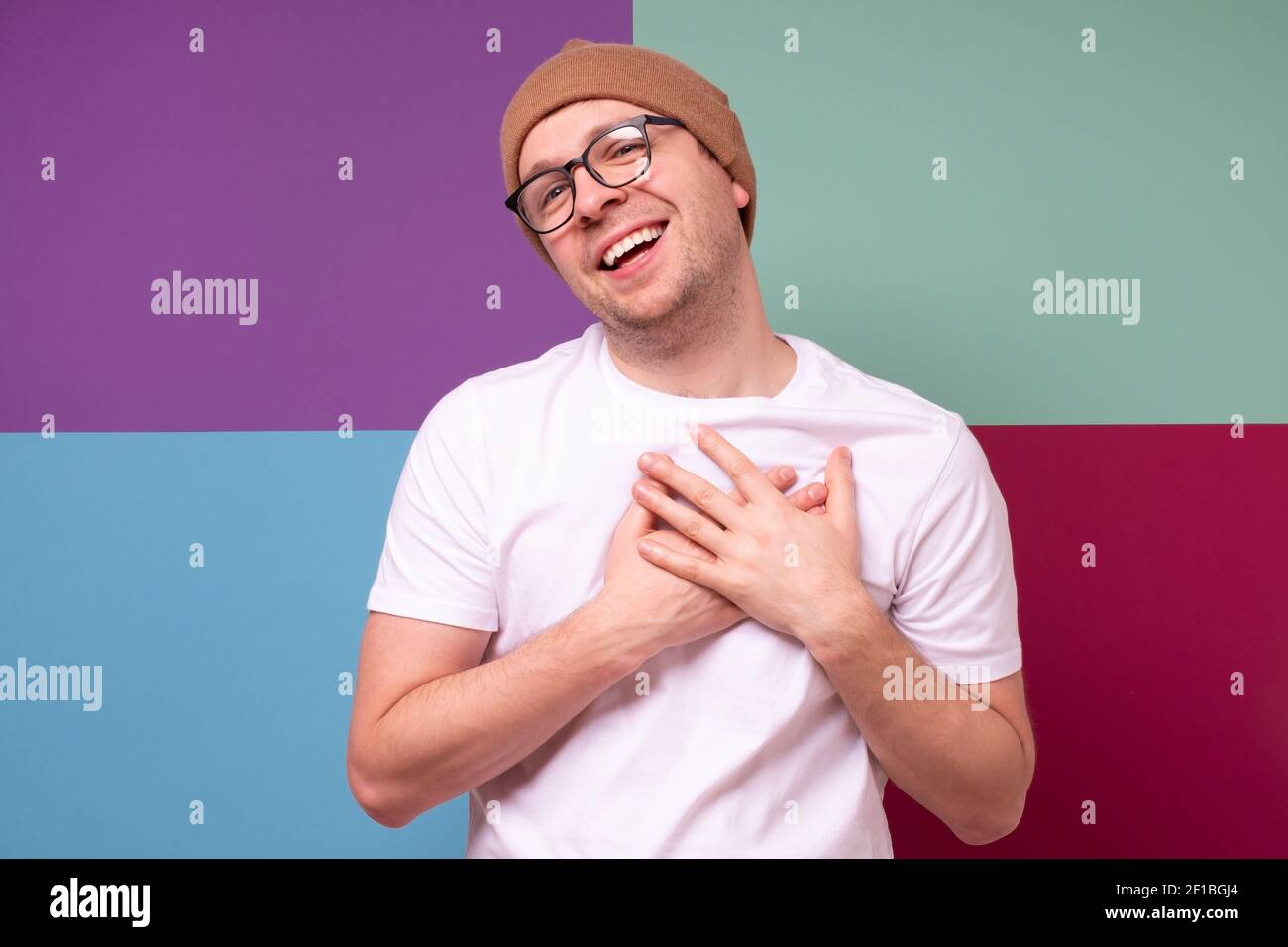 Happy friendly man being content to hear compliment expresses his ...