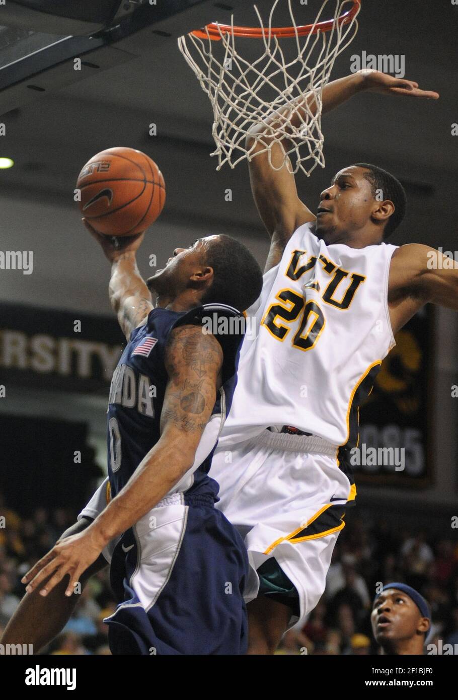 Nevada guard Brandon Fields, left, attempts to go up and under Virginia ...