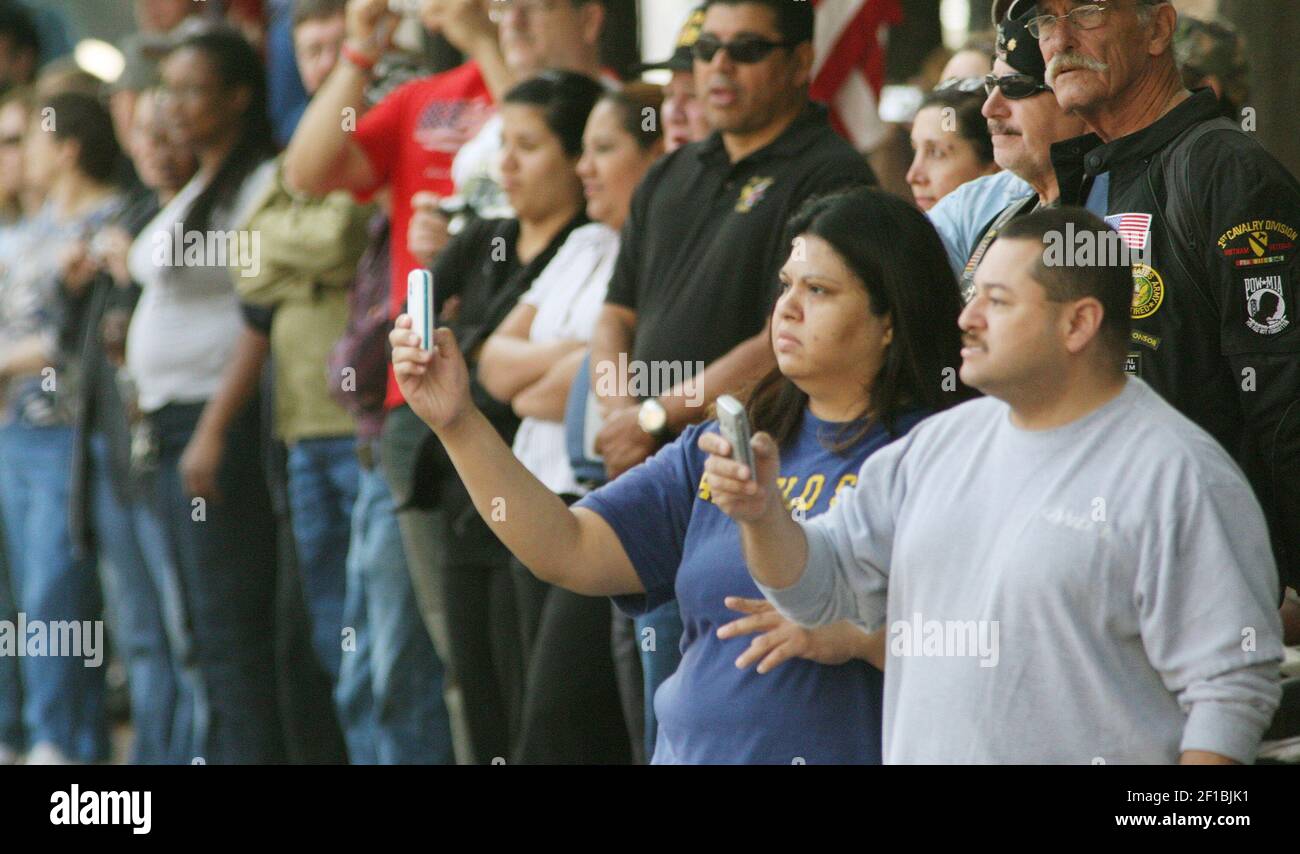 Sylvia and Carl Escobar take photos of their son Isaac, a sixth-grade ...