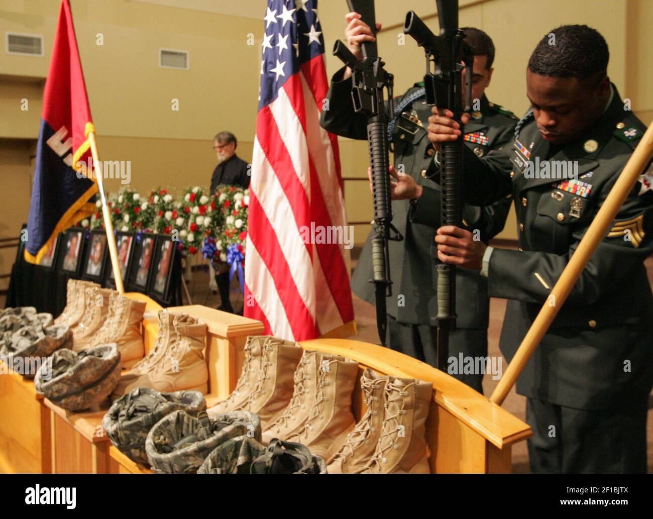 Two soldiers prepare the symbolic display before the memorial at Fort ...
