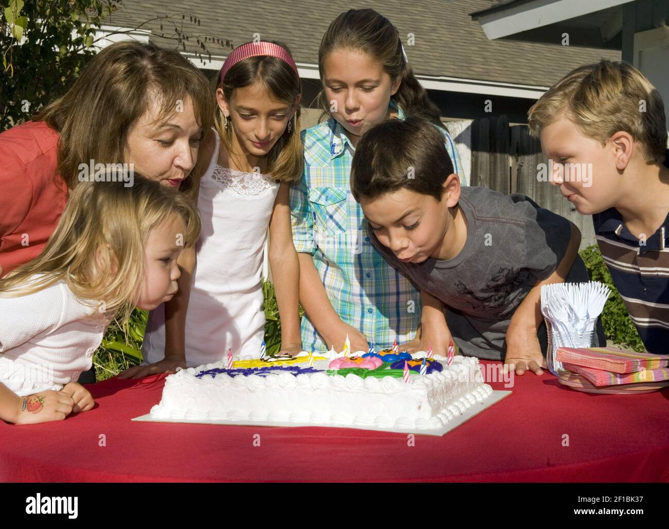 Project Cuddle founder Debbe Magnusen blows out the candles on a ...