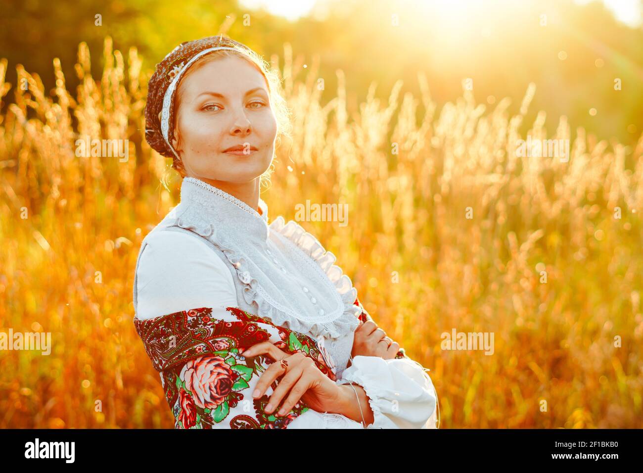 Young beautiful slovak woman in traditional costume on summer daisy ...