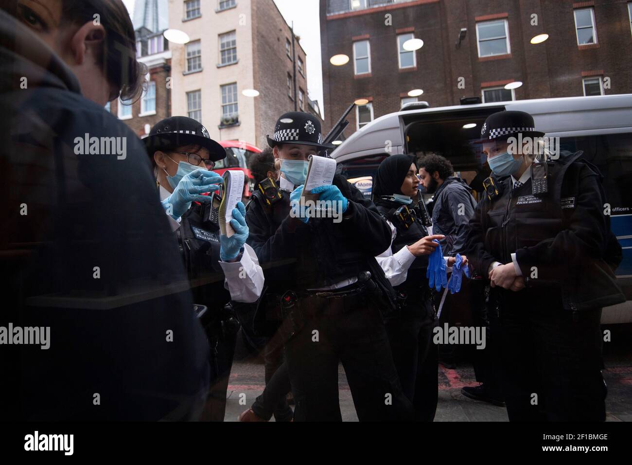 Female police officers and special constables stop and question a ...
