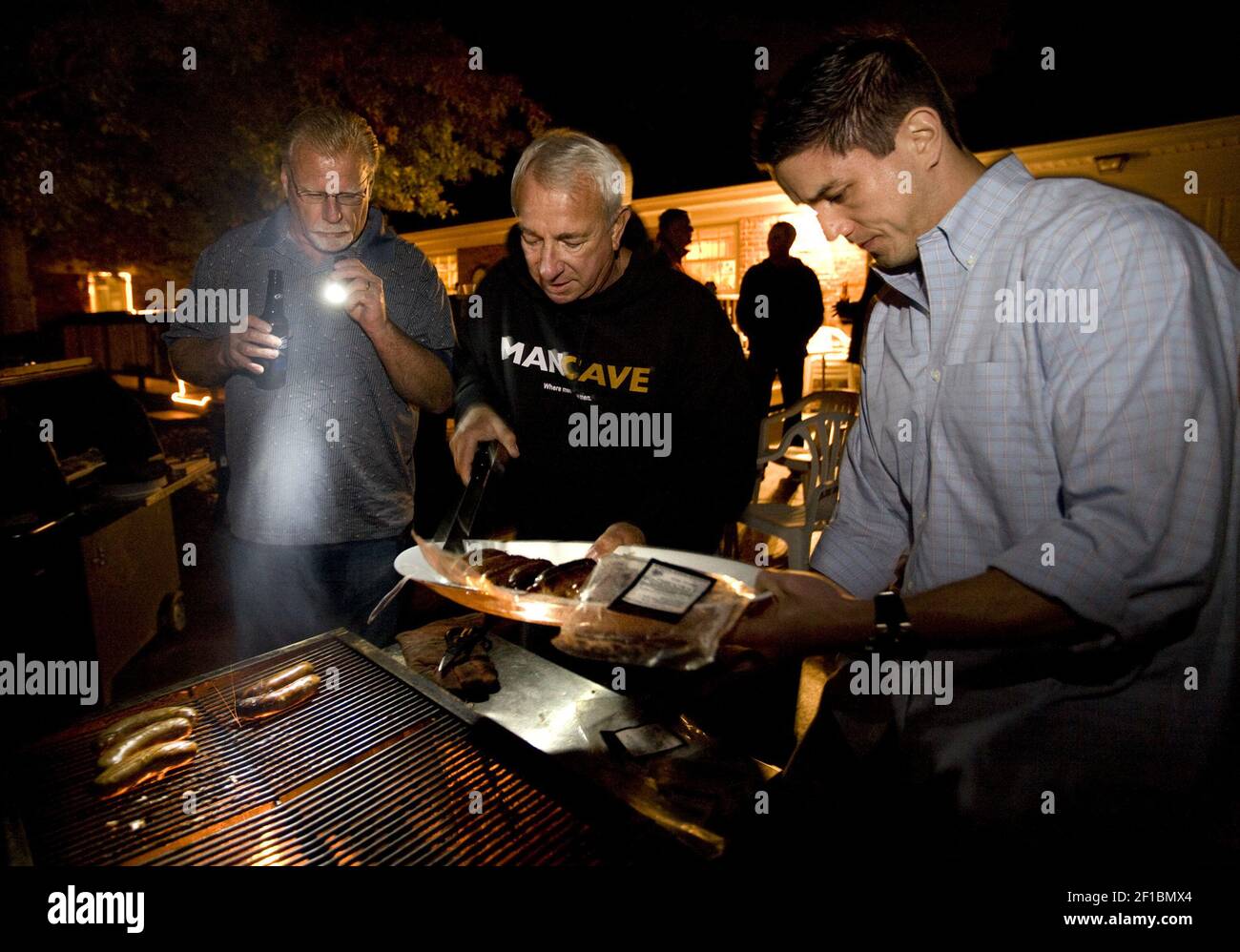 From left, Roger Klumb, Jim Mossey and Charlie McCoy grill various ...
