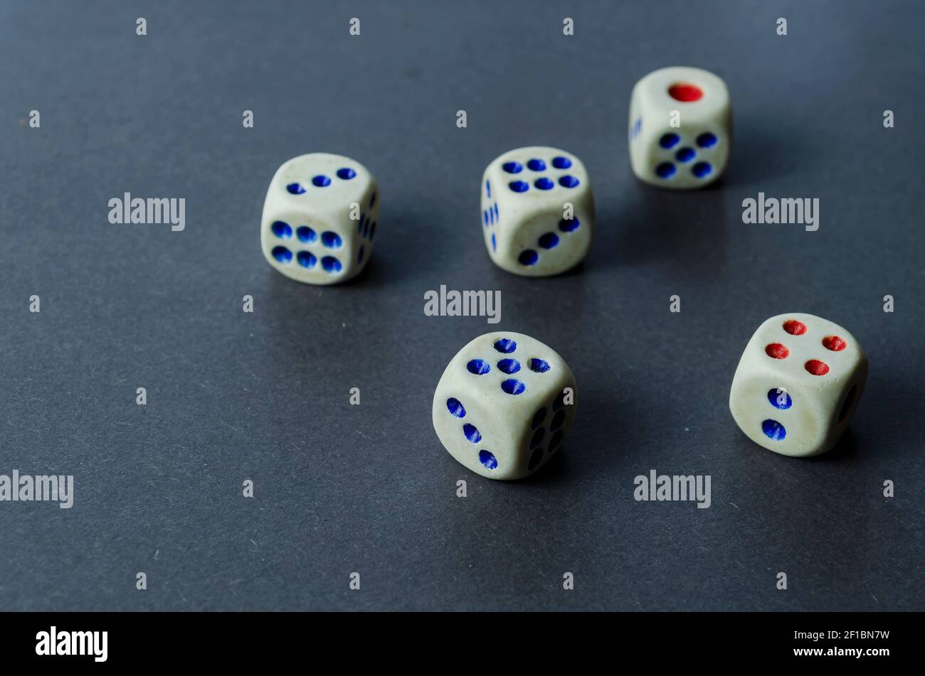 Old dice on a gray background. Five random white dice. Side view ...