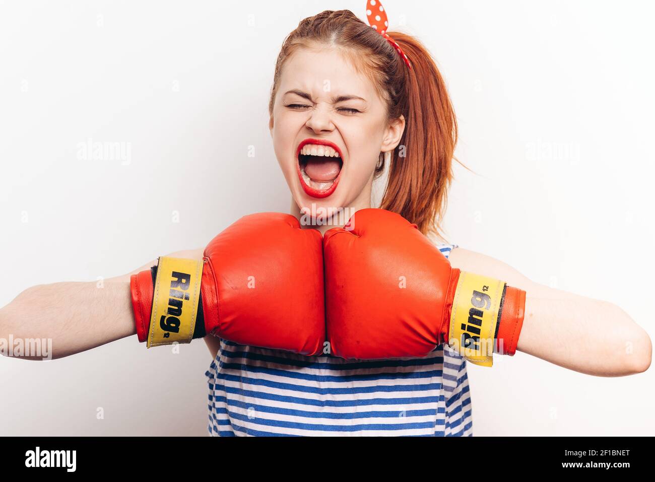 Strong woman boxing in red gloves bright makeup hairstyle light ...