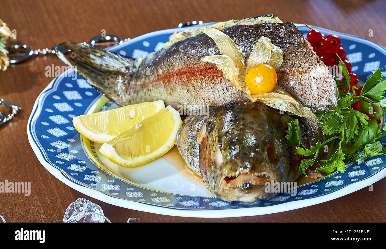 Fried stuffed fish on a platter festive menu Stock Photo - Alamy