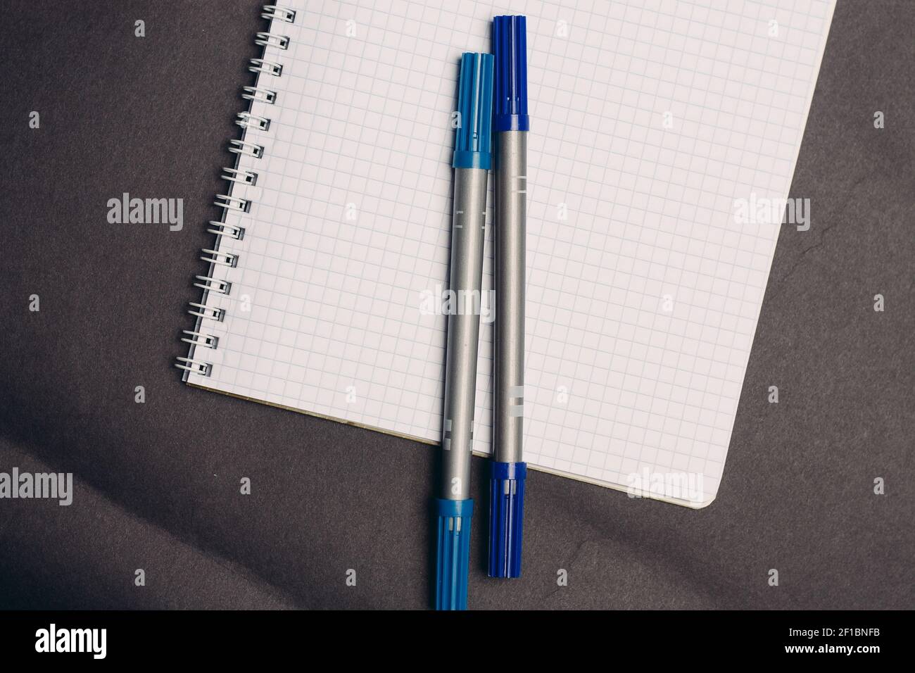 notepad with pens writing office gray background papers Stock Photo - Alamy