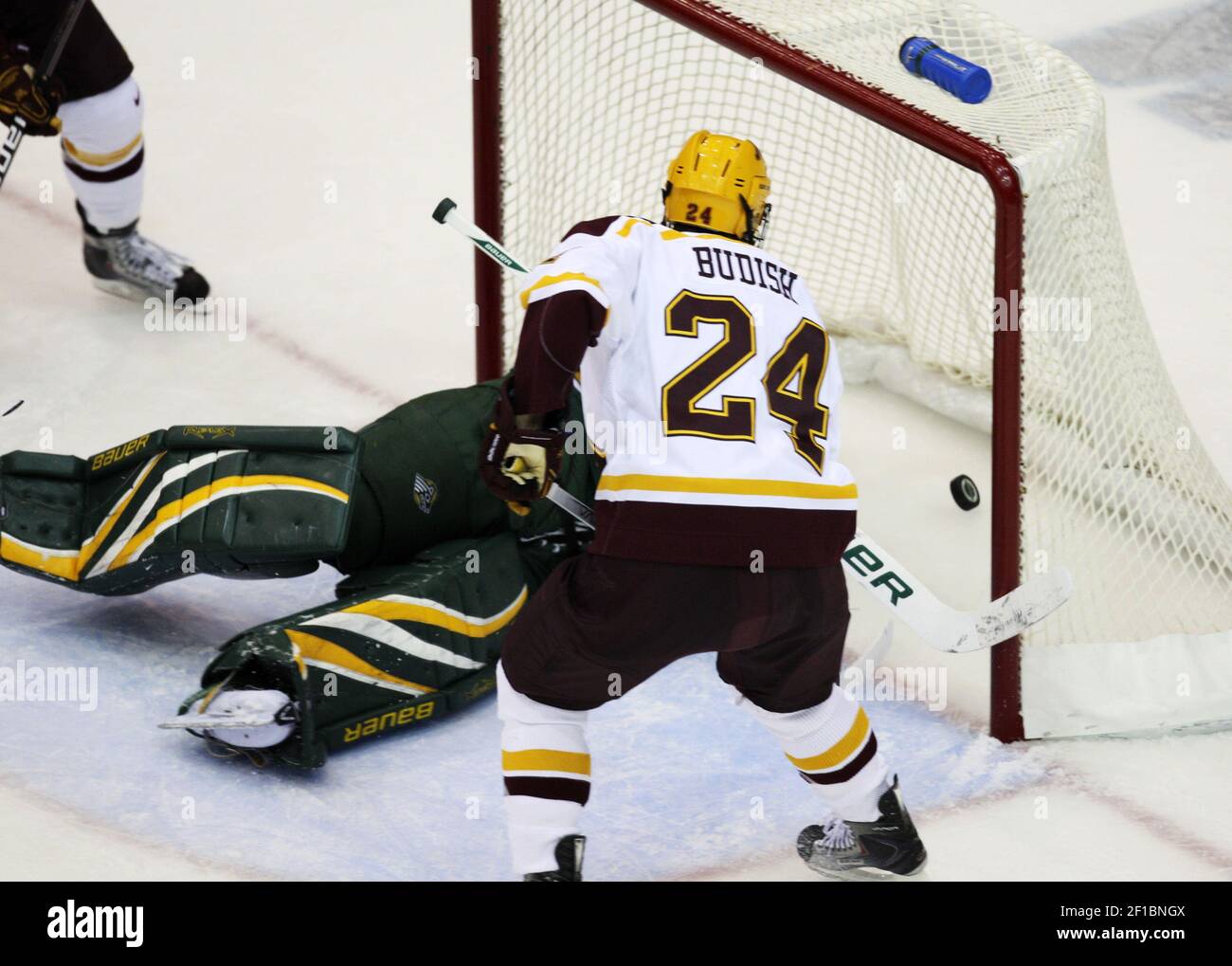 Minnesota's Zach Budish (24) put the puck past Alaska goalie Bryce ...